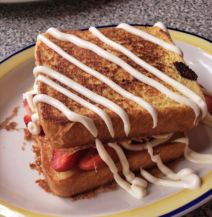 Stuffed French toast drizzled with sweet cream glaze and bursting with strawberries—dessert masquerading as breakfast, and fooling no one.