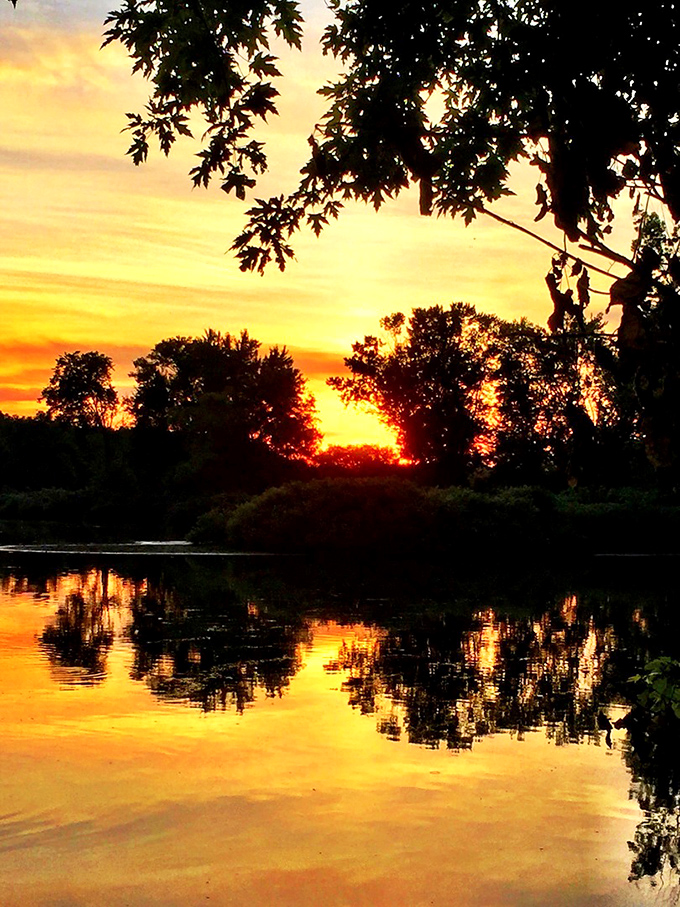 Sunset reflections on the Tuscarawas River paint daily masterpieces that no museum could ever properly capture.