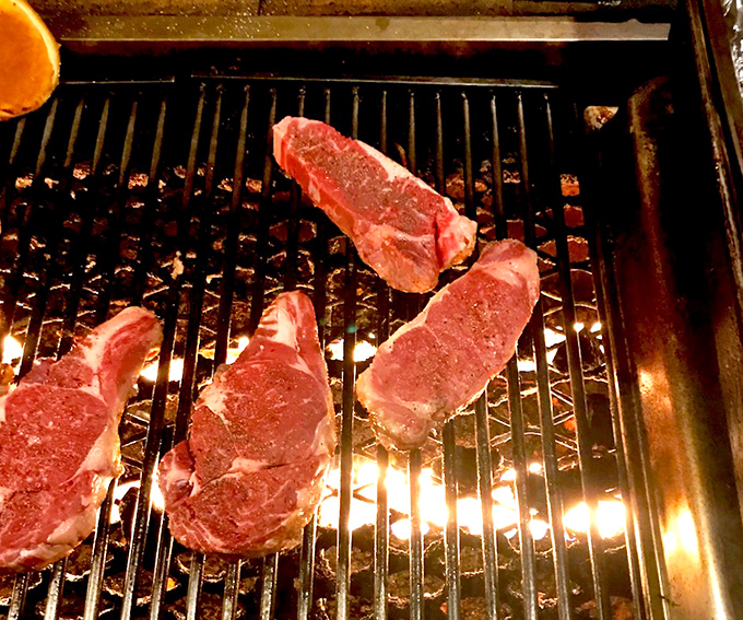 Raw steaks awaiting their fiery transformation. Like caterpillars before becoming butterflies, except these metamorphose into dinner rather than taking flight.