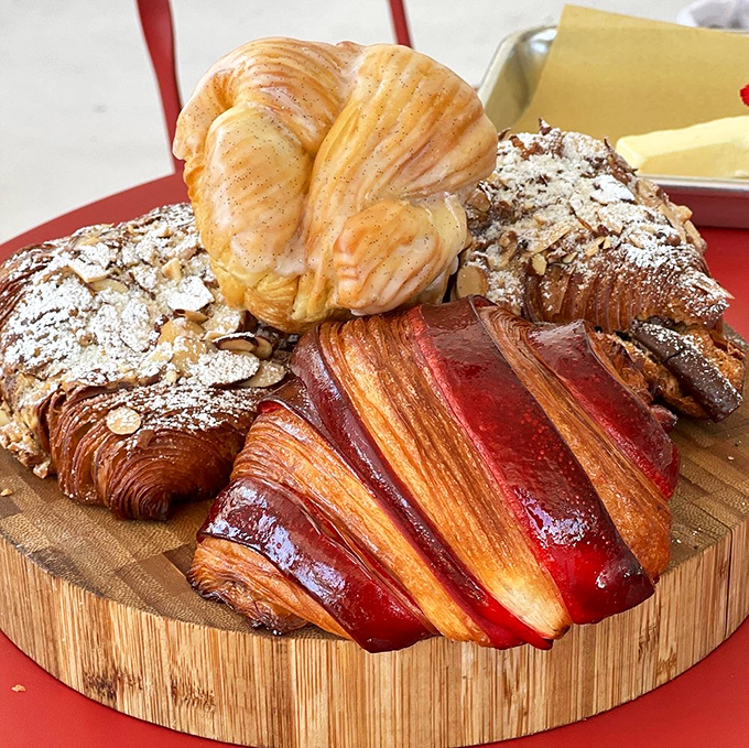 A pastry board that belongs in the Louvre. The raspberry croissant steals the spotlight with its ruby glaze and flaky perfection.