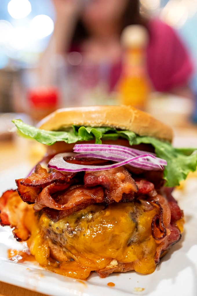 The Texas Burger arrives like a beautiful, messy declaration of independence from boring food. That melted cheese and bacon combo should require a warning label.