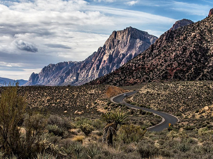 The road curves through geological wonders like a ribbon of possibility. Every turn promises new discoveries in this desert dreamscape.