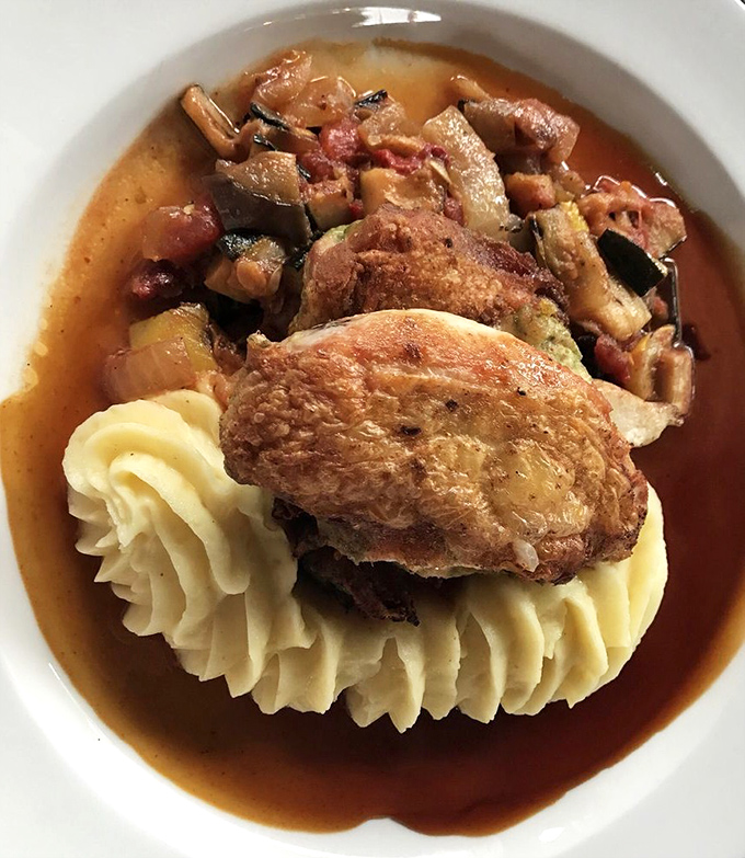 Comfort food elevated&mdash;tender chicken nestled on a cloud of mashed potatoes with a sauce that demands to be sopped up with bread.