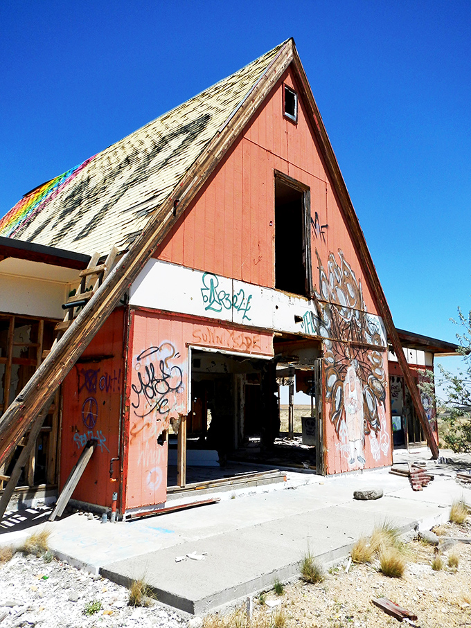 Graffiti transforms forgotten buildings into community canvases where every visitor leaves their mark on desert history.