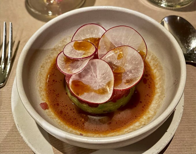 Tuna tartare that transforms raw fish into architectural brilliance. This delicate tower of flavor makes you wonder why we ever bothered cooking food in the first place.