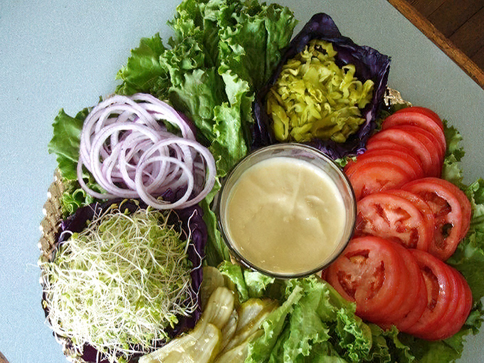 This vibrant veggie platter showcases the fresh, colorful ingredients that make every sandwich a celebration of California's agricultural bounty. 