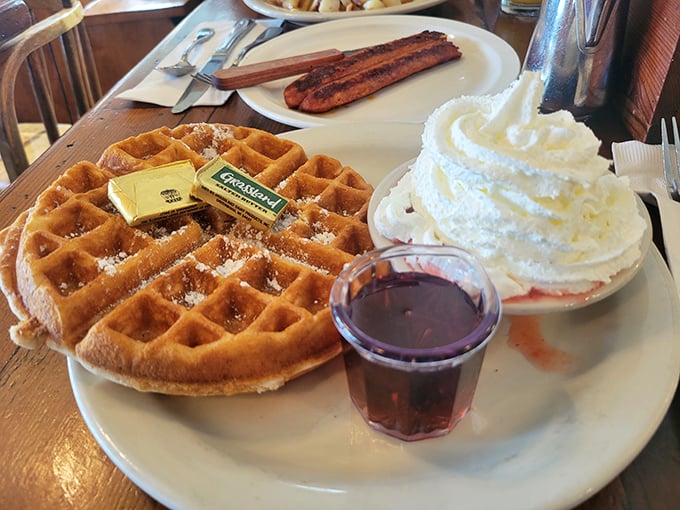 A waffle that's achieved the perfect golden-brown tan, with whipped cream and syrup standing by to transform it from great to transcendent.