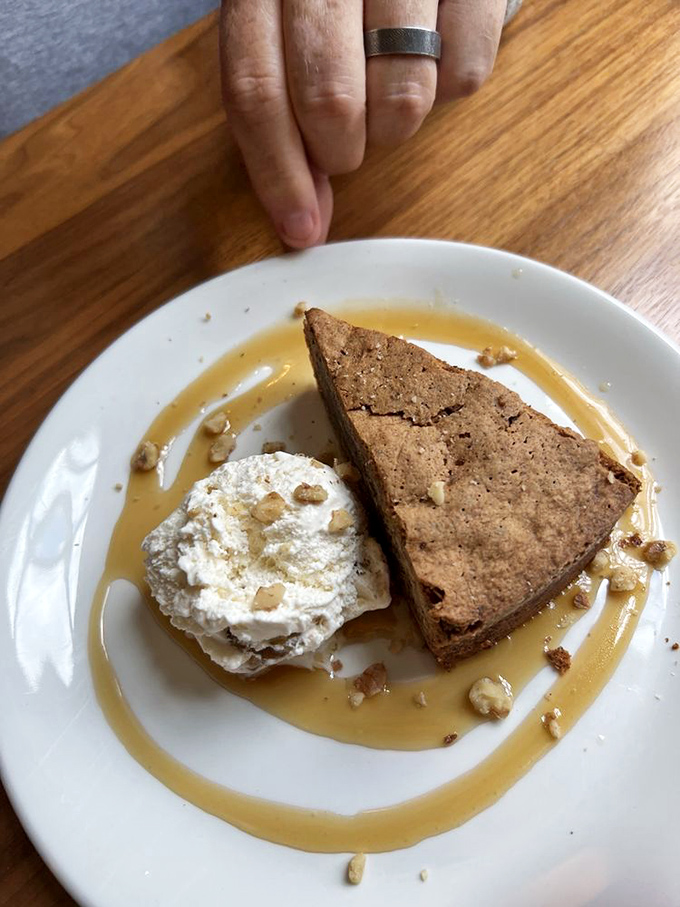 This walnut torte slice sits in golden sauce like a work of art you almost feel guilty eating.