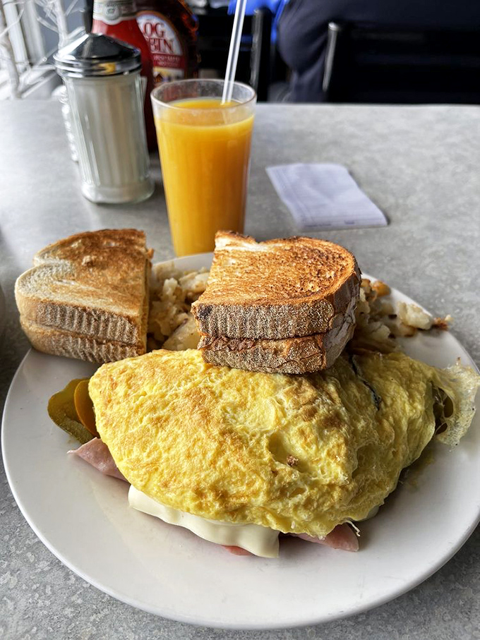 The Western omelet&mdash;a sunshine-yellow pillow of breakfast perfection paired with golden toast. Morning salvation on a plate.