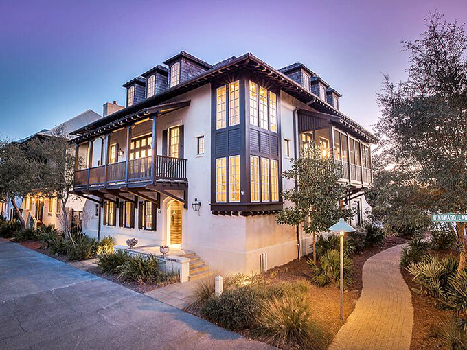 As twilight descends, windows glow like lanterns along winding pathways, transforming ordinary homes into magical beacons guiding evening strollers.