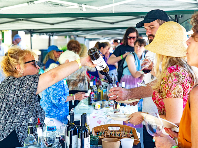 Hands eagerly reach for wine pours at the festival, proving that in Los Olivos, community is built one glass at a time.