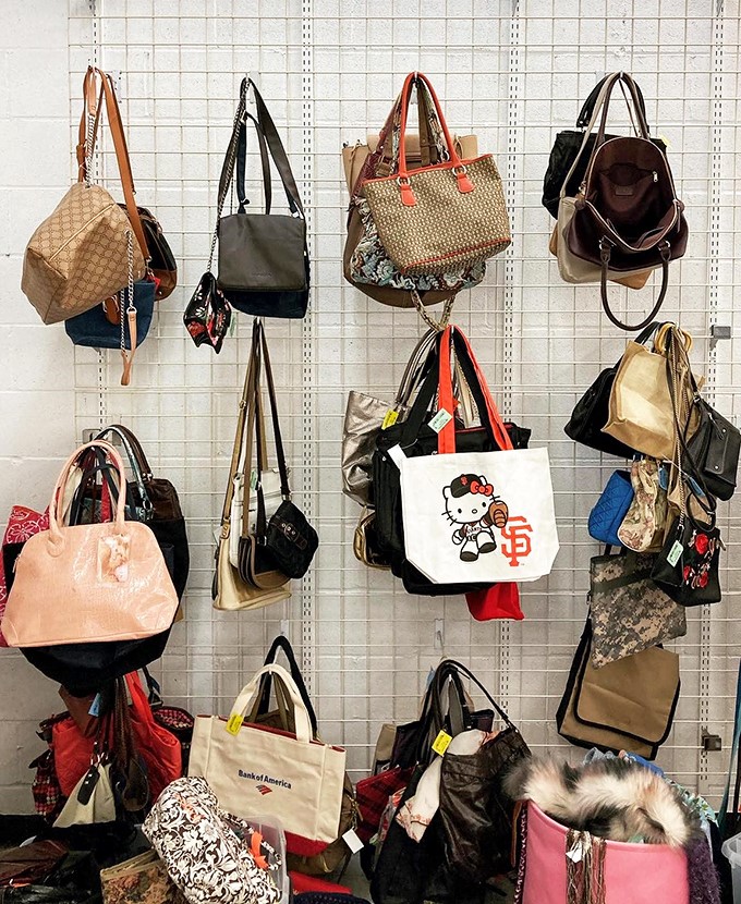 Handbag heaven where designer dreams and practical totes hang together in democratic fashion harmony.
