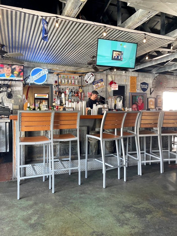 The bar at Crabby Bill's: where locals perch like seabirds and visitors quickly learn why this place has endured. Cold drinks and warm conversations flow freely.