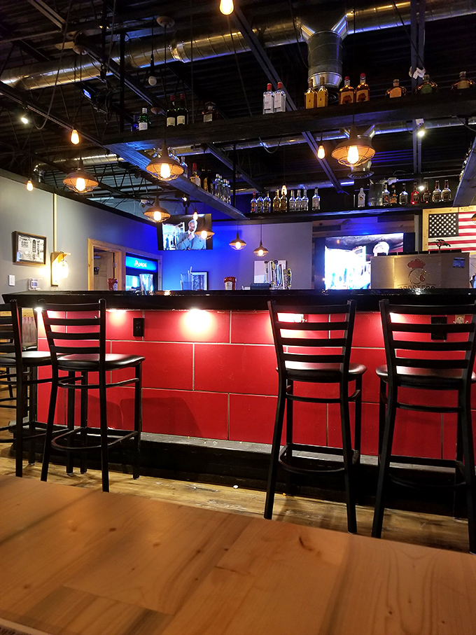 The bar area combines industrial chic with hometown warmth&mdash;exactly where you want to perch while debating which wing sauce deserves your eternal loyalty.