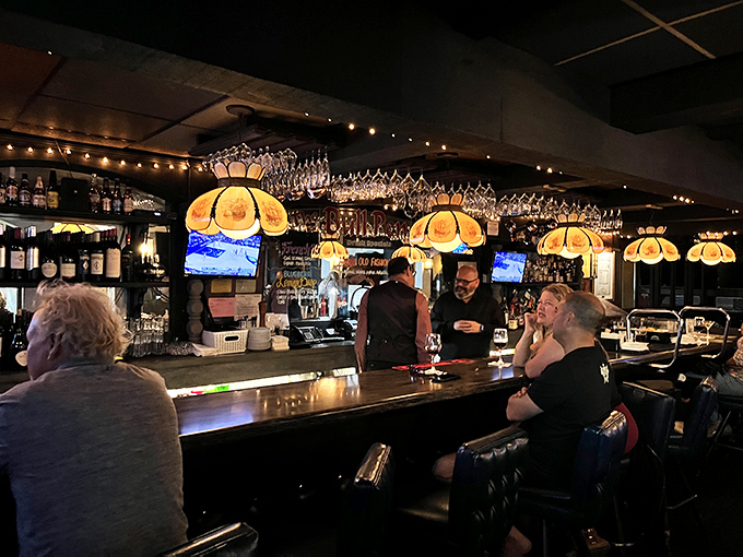 The bar area glows with vintage charm, where regulars gather and first-timers quickly understand why this place has endured for generations.