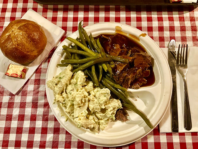 Brisket, green beans, and potato salad: the holy trinity of comfort food, arranged on a plate like an artist's palette of deliciousness.