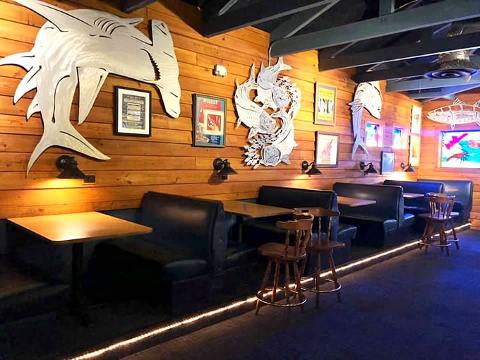 The booth section&mdash;where seafood dreams and comfortable seating unite. Those metal fish sculptures watch over diners like silver guardians.