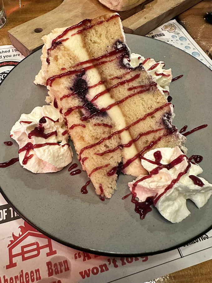 This towering slice of cake stands as proof that some desserts are worth loosening your belt and abandoning all dietary resolutions.