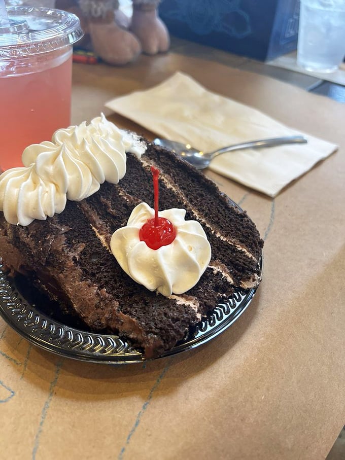 A slice of chocolate cake with a cherry on top &ndash; because after conquering a fortress of crab shells, you've earned every decadent forkful.