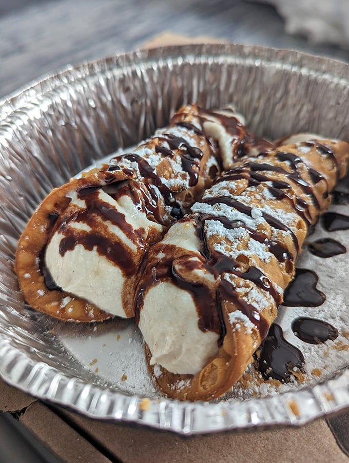 These cannolis aren't just dessert &ndash; they're the sweet encore after your pizza concert, with chocolate drizzle playing the final delicious note.