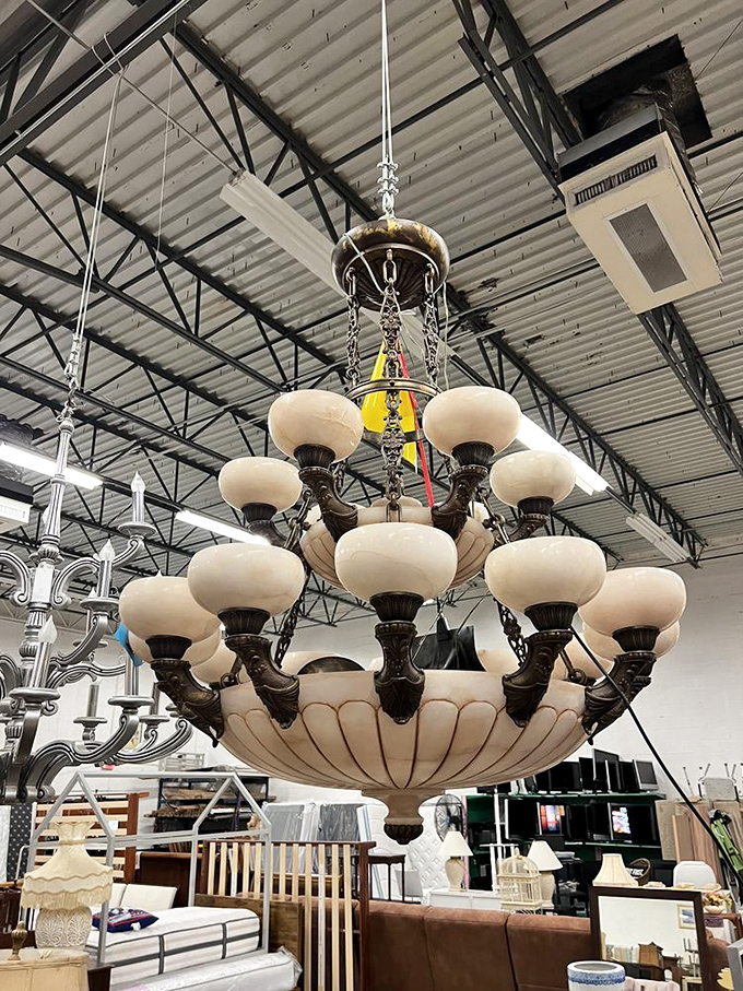 A magnificent chandelier dangles from industrial rafters&mdash;proof that elegance can be found in the most unexpected places, especially when you're thrift shopping.