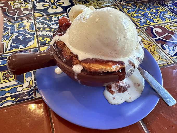 This isn't just dessert; it's a warm cherry cobbler topped with ice cream melting into all the right places &ndash; the perfect sweet finale.