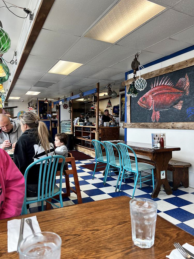 The classic blue-and-white interior where families create memories one bite of chowder at a time. That red fish painting has seen it all.