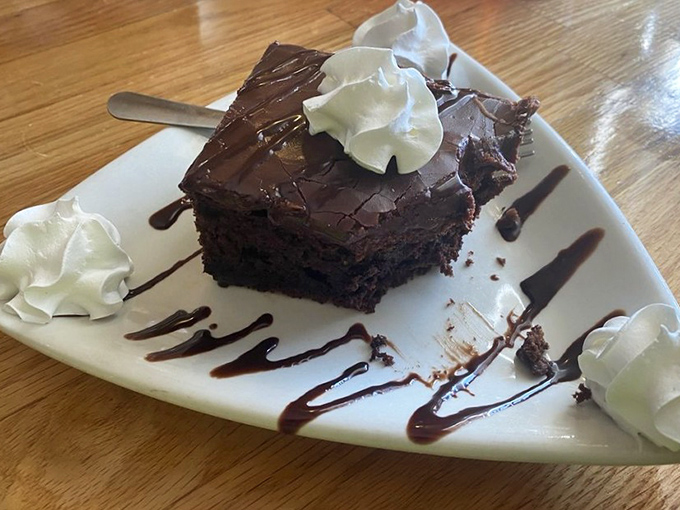 A chocolate cake so rich it should come with its own tax bracket. Those dollops of whipped cream aren't garnish &ndash; they're necessary indulgence.