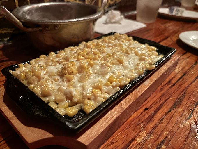 Corn cheese—the ultimate comfort food crossover. This bubbling skillet of sweet corn under a blanket of melted cheese speaks a universal language of satisfaction.