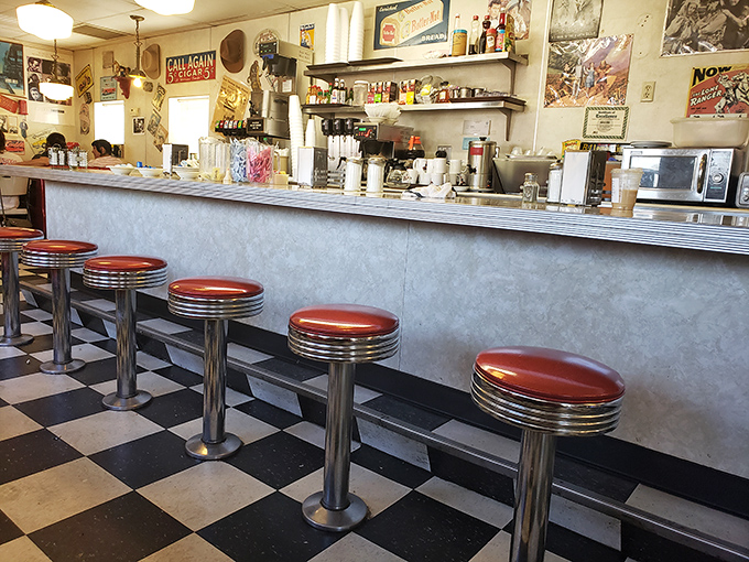 Counter seating where solo diners become temporary family, watching short-order ballet performed by cooks who've mastered the breakfast symphony.