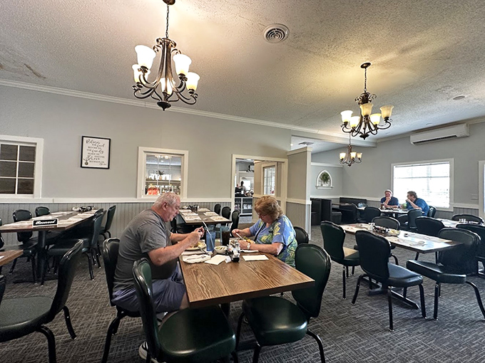 Diners enjoying their meals in peaceful surroundings, under soft chandelier light. No phones in sight&mdash;just people connecting over food that demands your full attention.