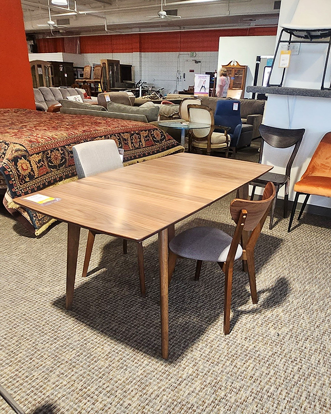 This walnut dining set whispers "Mad Men dinner party" while that ornate rug in the background is practically shouting "I belong in a mansion!"
