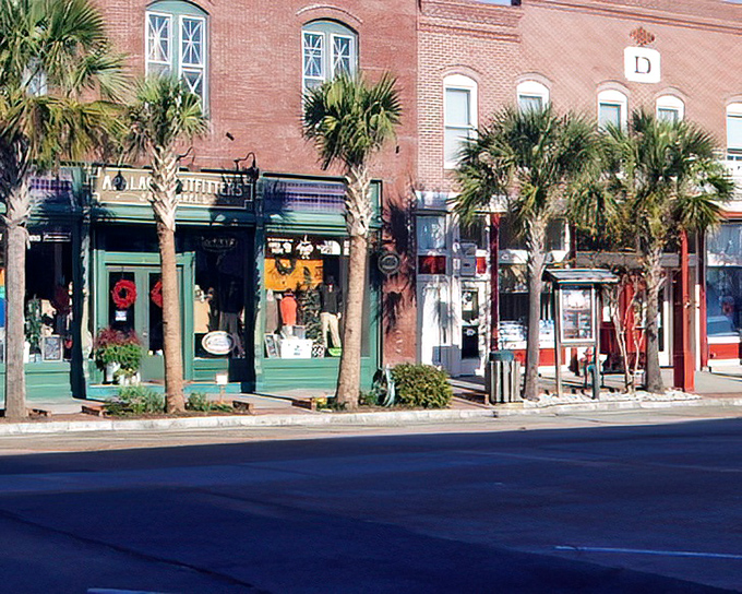 Palm trees stand guard over colorful storefronts, creating that quintessential Florida streetscape where shopping becomes a tropical adventure.