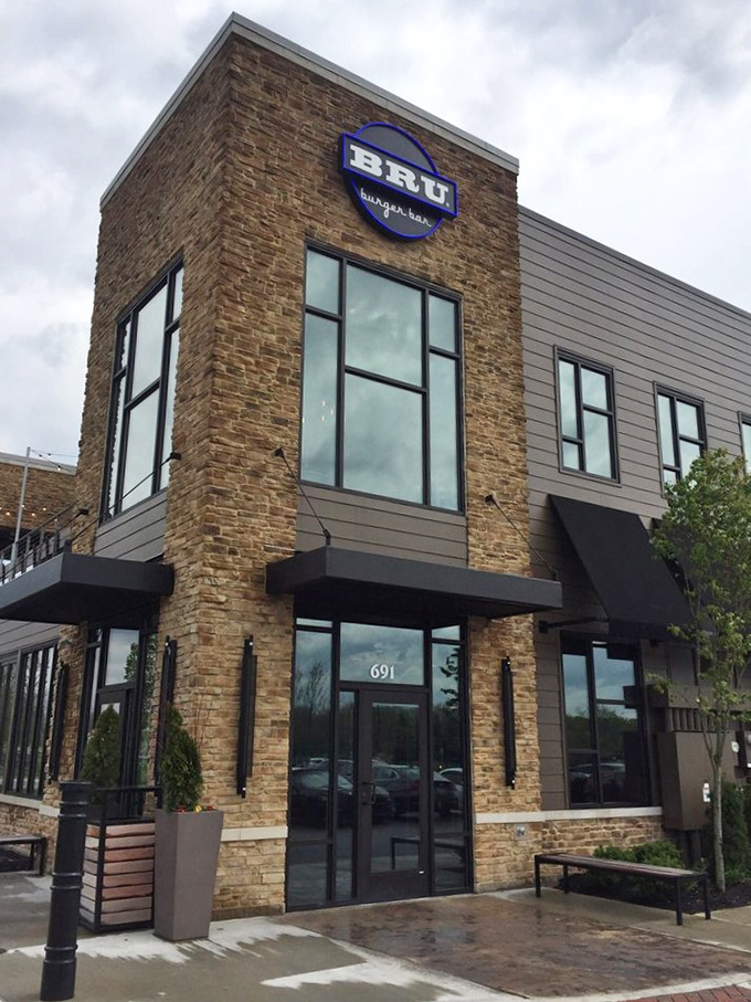 The entrance beckons like a modern-day castle of culinary delights, promising burger magic within its stone walls.