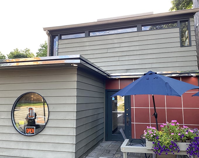 Even the entrance feels like a welcome hug. Those blue umbrellas stand guard like sentinels protecting the sacred ritual of comfort food.