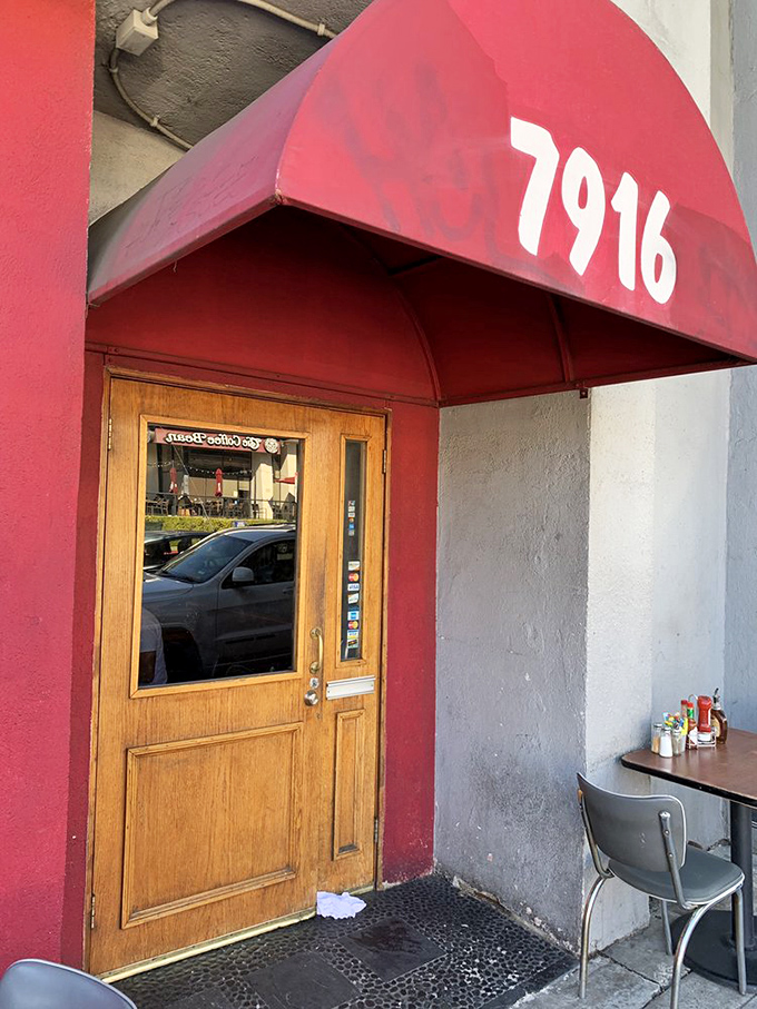 The wooden door beneath that bold red awning isn't just an entrance – it's a portal to pancake nirvana that's worth every minute in line.