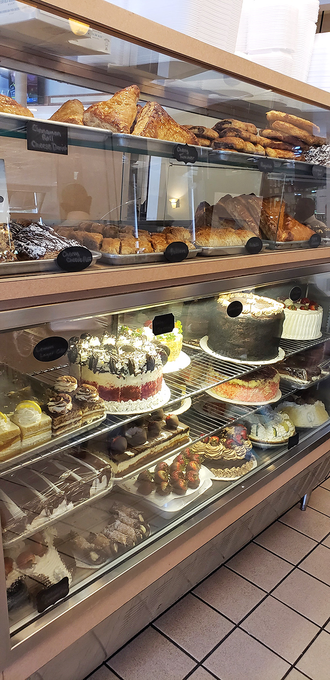 The bakery case&mdash;where diet plans go to die and "I'll just have a bite" becomes the lie you tell yourself before ordering a whole cake.