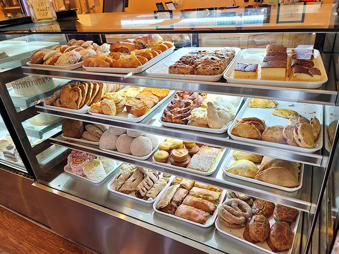 The display case isn't just storage&mdash;it's a museum of carbohydrate artistry where every shelf tells a different delicious story.