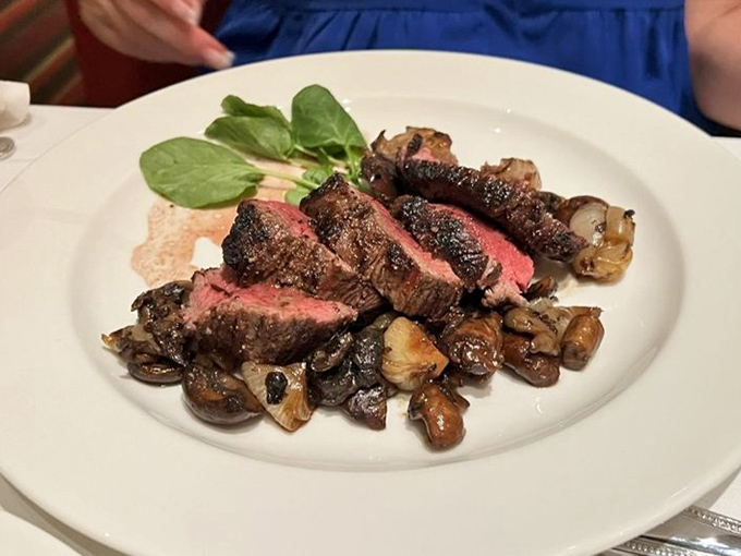 Sliced steak revealing that perfect pink center. The mushrooms aren't sidekicks&mdash;they're essential supporting actors in this meaty drama.