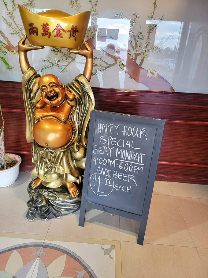 A laughing Buddha statue guards the happy hour sign&mdash;because even enlightenment is easier to achieve with $1.99 beer on Mondays.