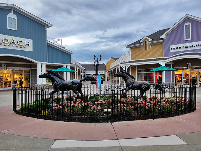 The colorful storefronts surrounding the horse sculpture create a retail rainbow, with Coach's blue, Tommy Hilfiger's purple, and everything in between.