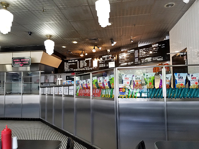 The counter view &ndash; where anticipation builds as you scan the menu. Every great cheesesteak experience begins with this moment.