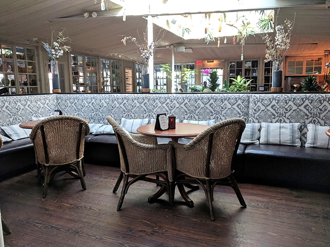 Wicker chairs and patterned banquettes create little islands of intimacy in a space designed for both conversation and contemplation.