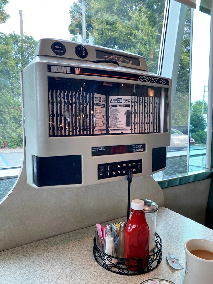 That nostalgic tabletop jukebox brings back memories of quarters well-spent, offering the perfect soundtrack to your meal—because great food deserves great music.