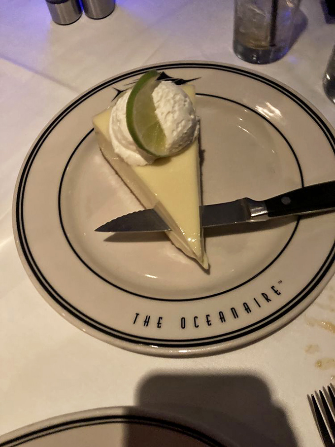 Key lime pie that captures Florida sunshine in every bite, topped with a dollop of whipped cream and that essential lime wedge.
