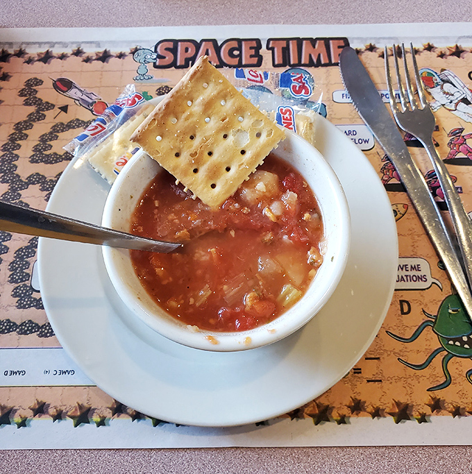 A humble cup of soup with crackers&mdash;proving that sometimes the simplest pleasures deliver the most profound satisfaction.