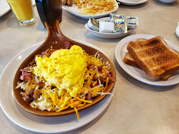 Morning glory in a skillet&mdash;eggs crowning a mountain of potatoes, meat, and cheese, with toast standing guard against hunger.