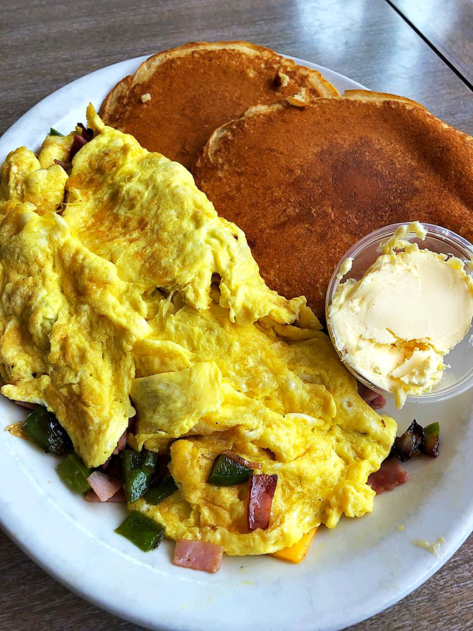 This isn't just an omelet&mdash;it's breakfast architecture, with perfectly folded eggs housing a treasure of colorful vegetables and melted cheese.