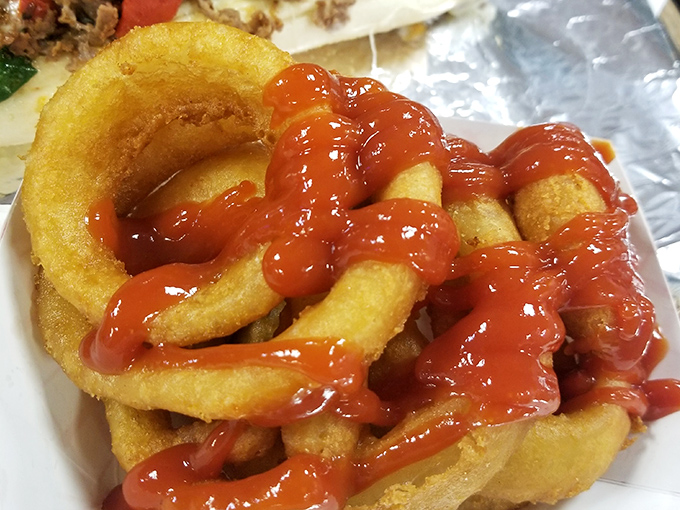 Onion rings wearing their ketchup crowns with pride. These golden halos of happiness prove that side dishes deserve the spotlight too.