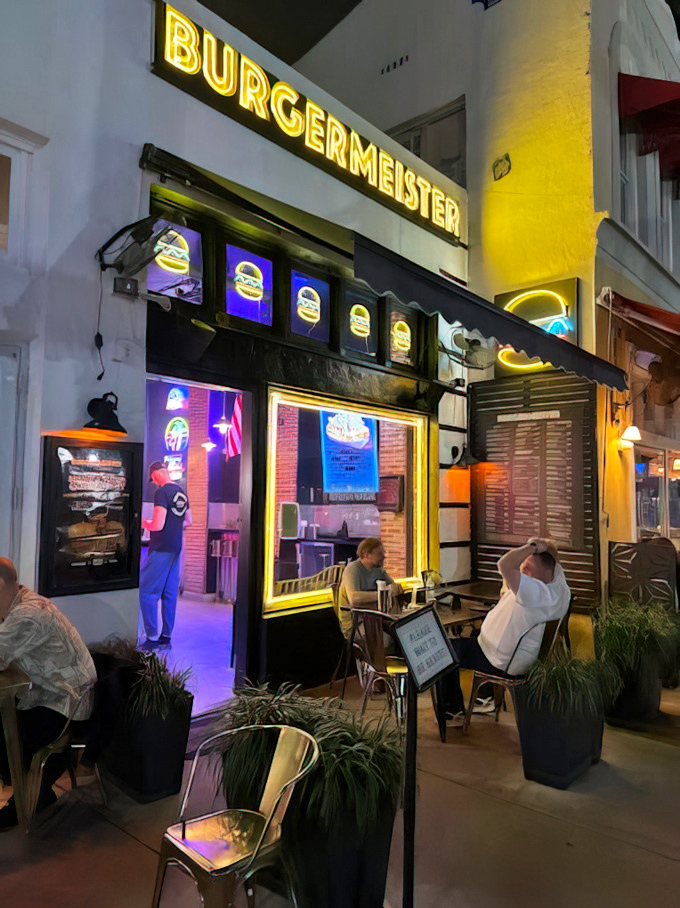 As night falls, Burgermeister's glow transforms from mere restaurant to urban legend, where burger dreams come true under Miami stars.